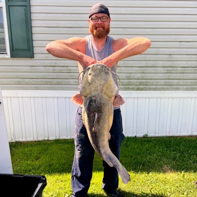 Bowfisherman Wrestles Record Catfish from a Creek | Outdoor Life